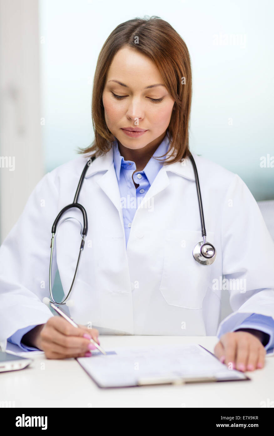 busy doctor with laptop computer and clipboard Stock Photo - Alamy
