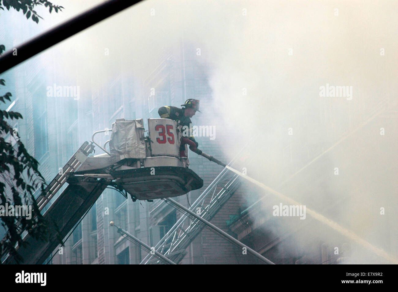 Firefighter sprays water on collapsed building. Building Collapse on ...