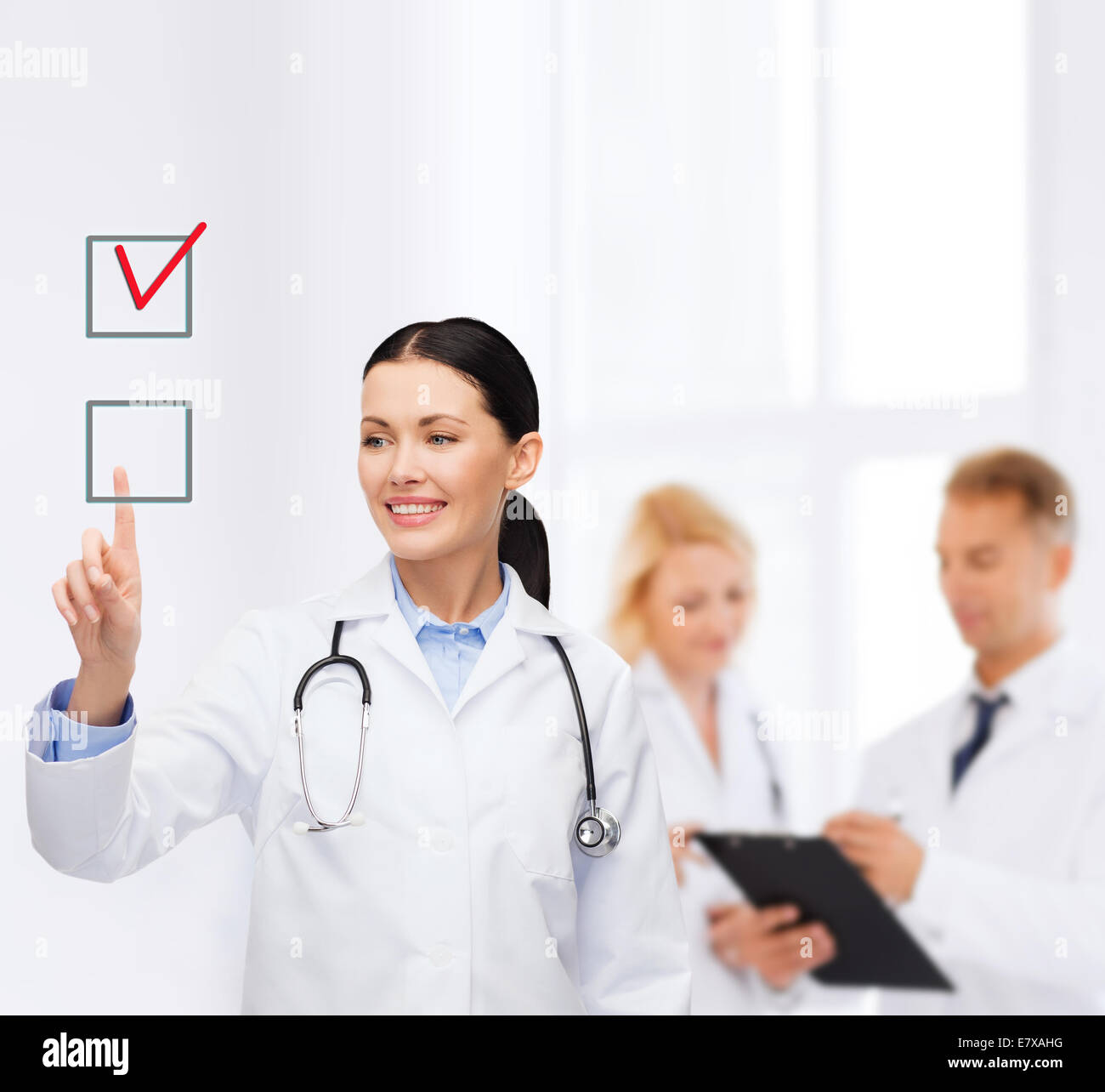 smiling female doctor pointing checkbox Stock Photo - Alamy