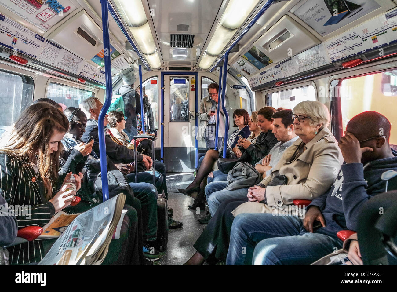Passengers riding a London tube train Stock Photo - Alamy