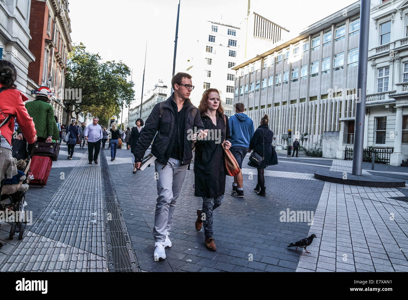 A couple walking down a London Street Stock Photo - Alamy