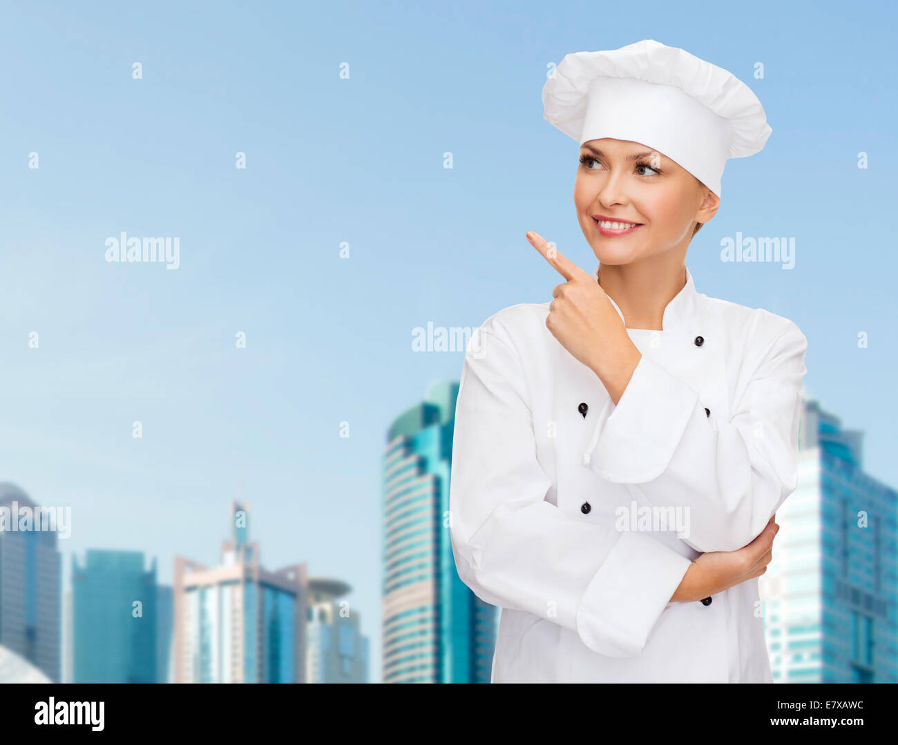 smiling female chef pointing finger to sonething Stock Photo - Alamy
