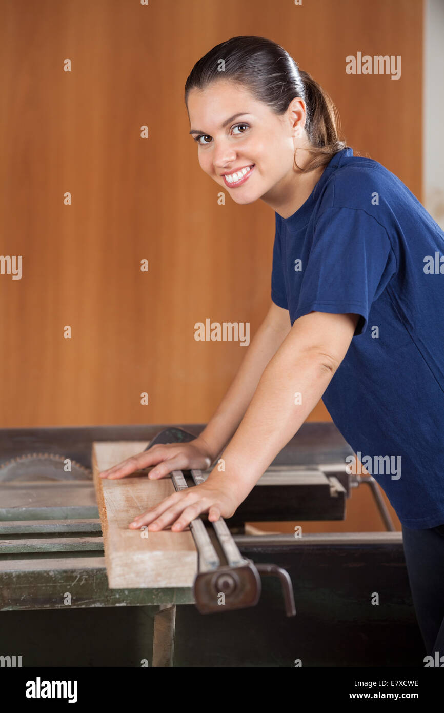 Female Carpenter Using Tablesaw In Workshop Stock Photo - Alamy