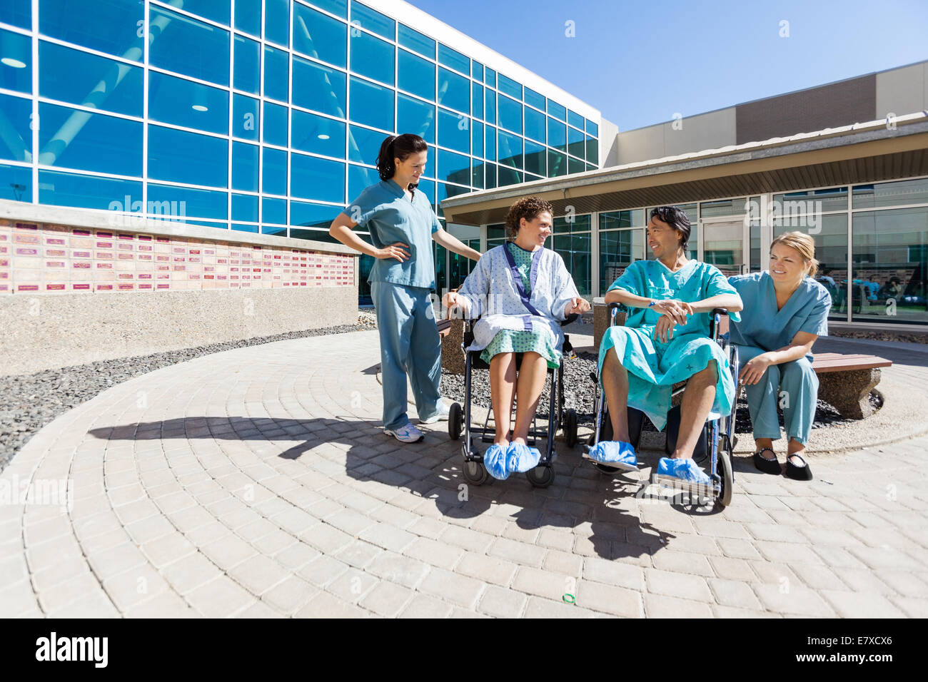 Patients On Wheelchair By Nurses Outside Hospital Building Stock Photo ...
