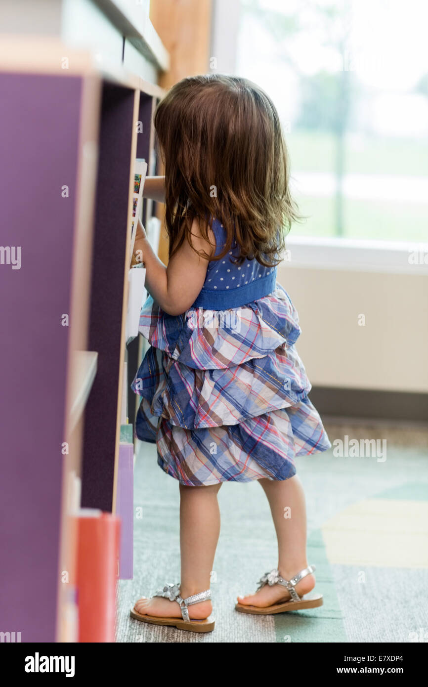 Girl Selecting Book From Bookshelf Stock Photo - Alamy Girl Selecting Book From Bookshelf Stock Photo - Alamy