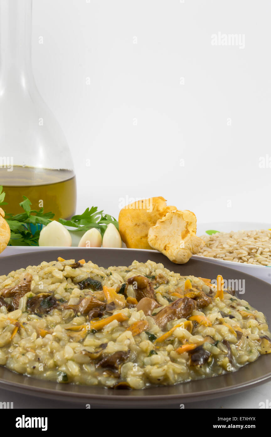 A plate of "risotto" with mushrooms and its ingredients on white ...