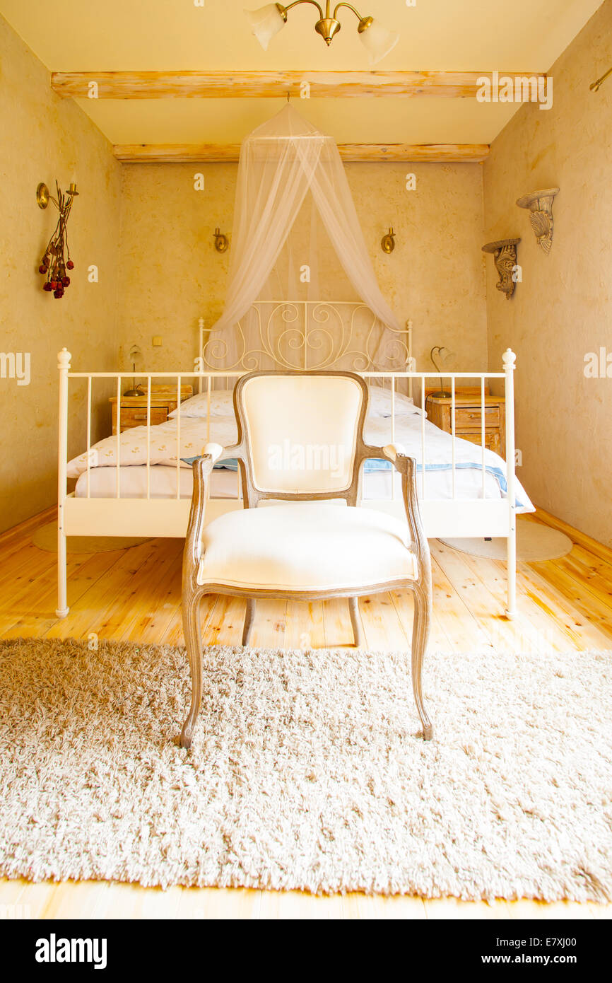 Interior of nice bedroom in vintage rural style. Room with comfortable ...