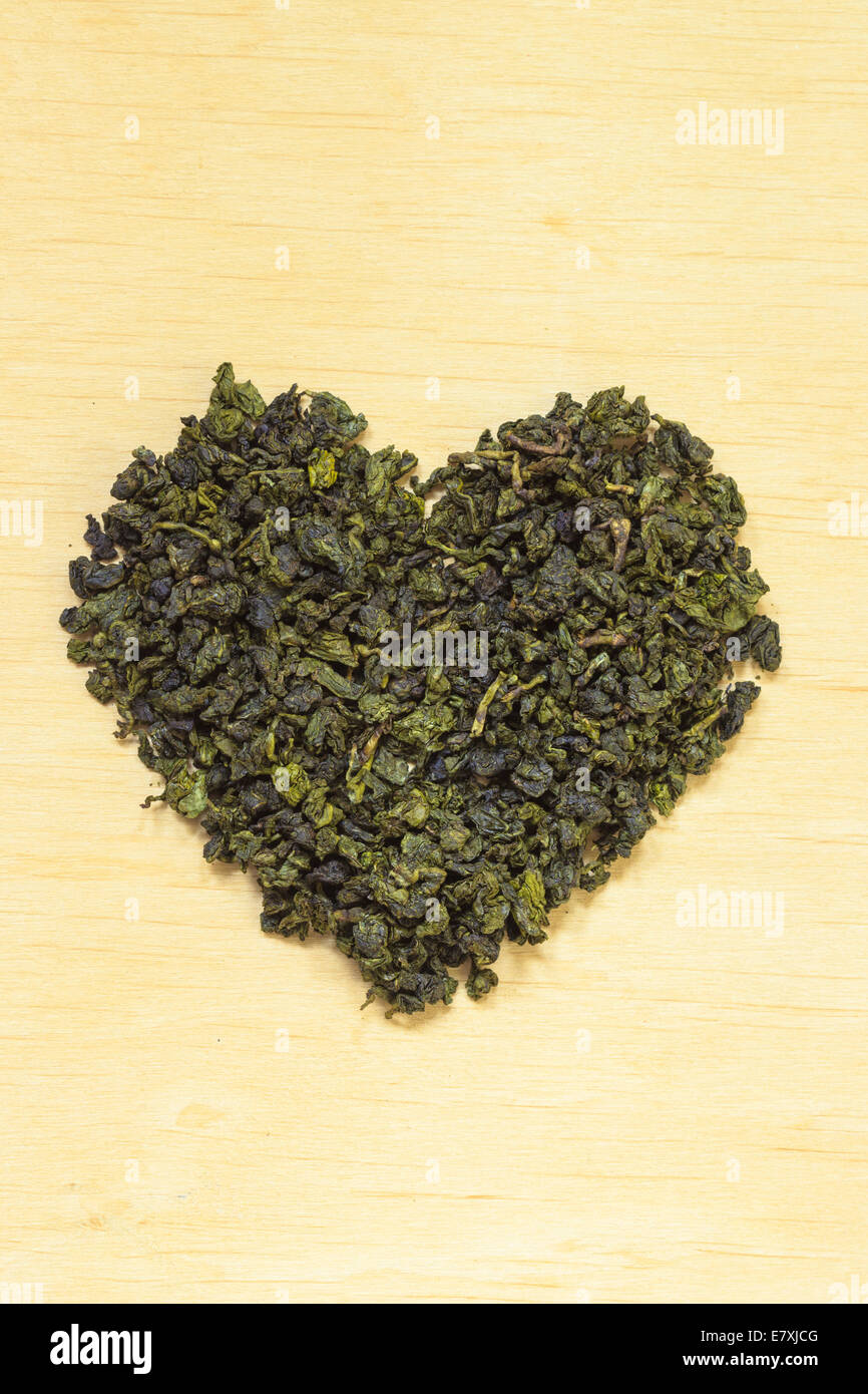 Diet healthcare concept. Green tea heart shaped on wooden surface ...