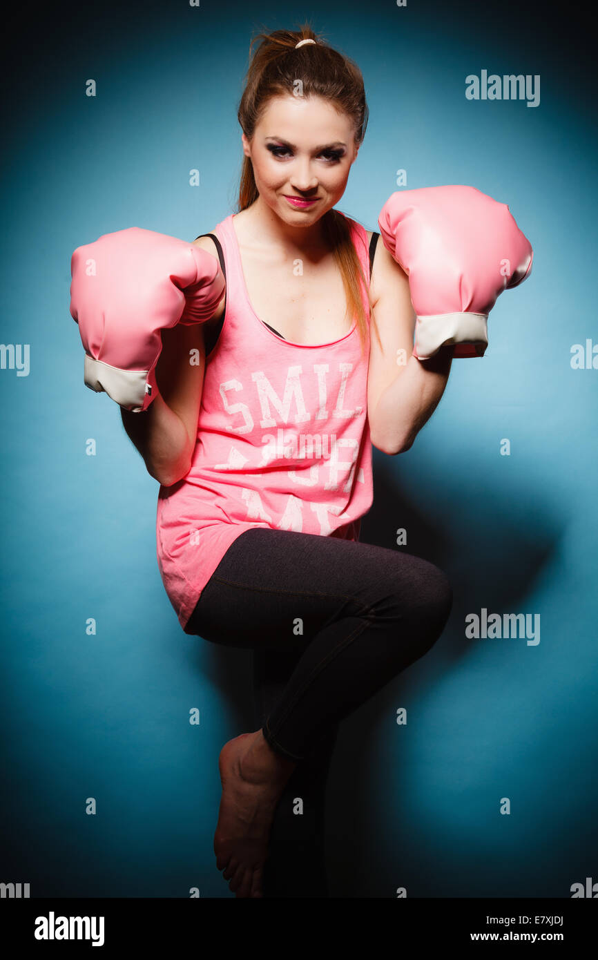 Funny girl female boxer model wearing big fun pink gloves playing ...