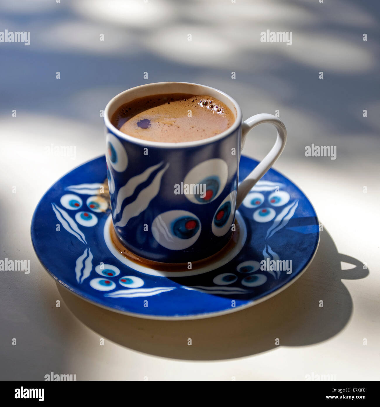 Turkish coffee in blue cup with coffee spilled on saucer Stock Photo ...