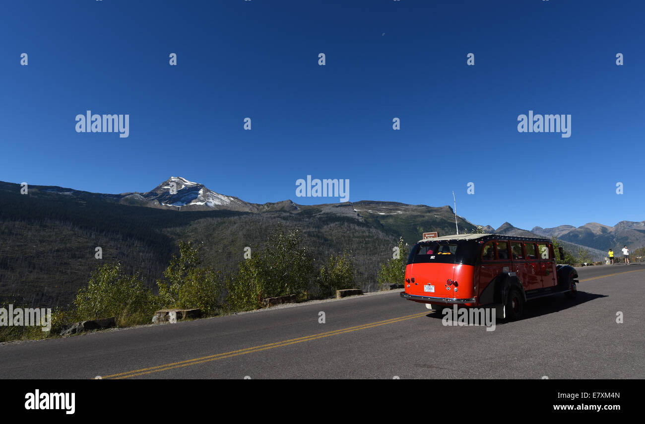 A Red Jammer Bus and view of Heavens Peak from Going-to-the-Sun Road in ...