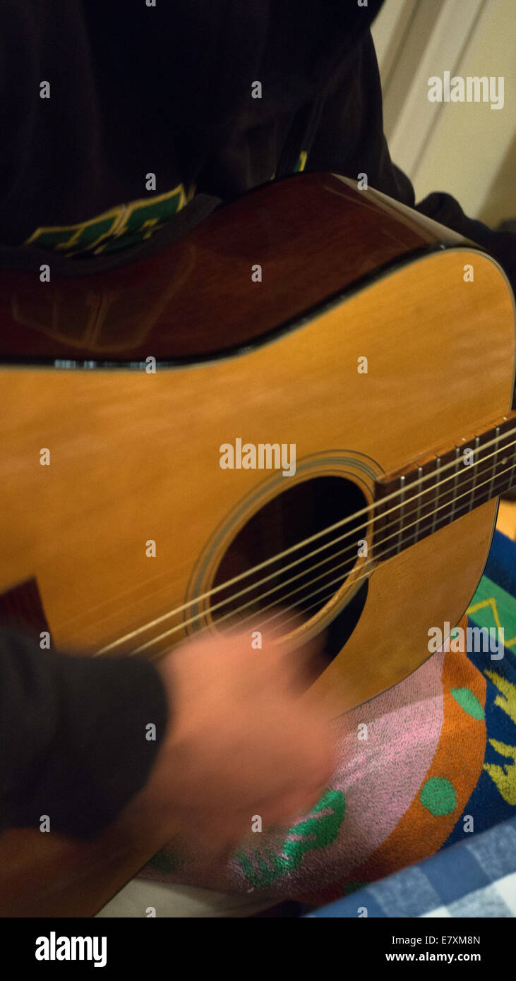 Strumming the guitar hi-res stock photography and images - Alamy