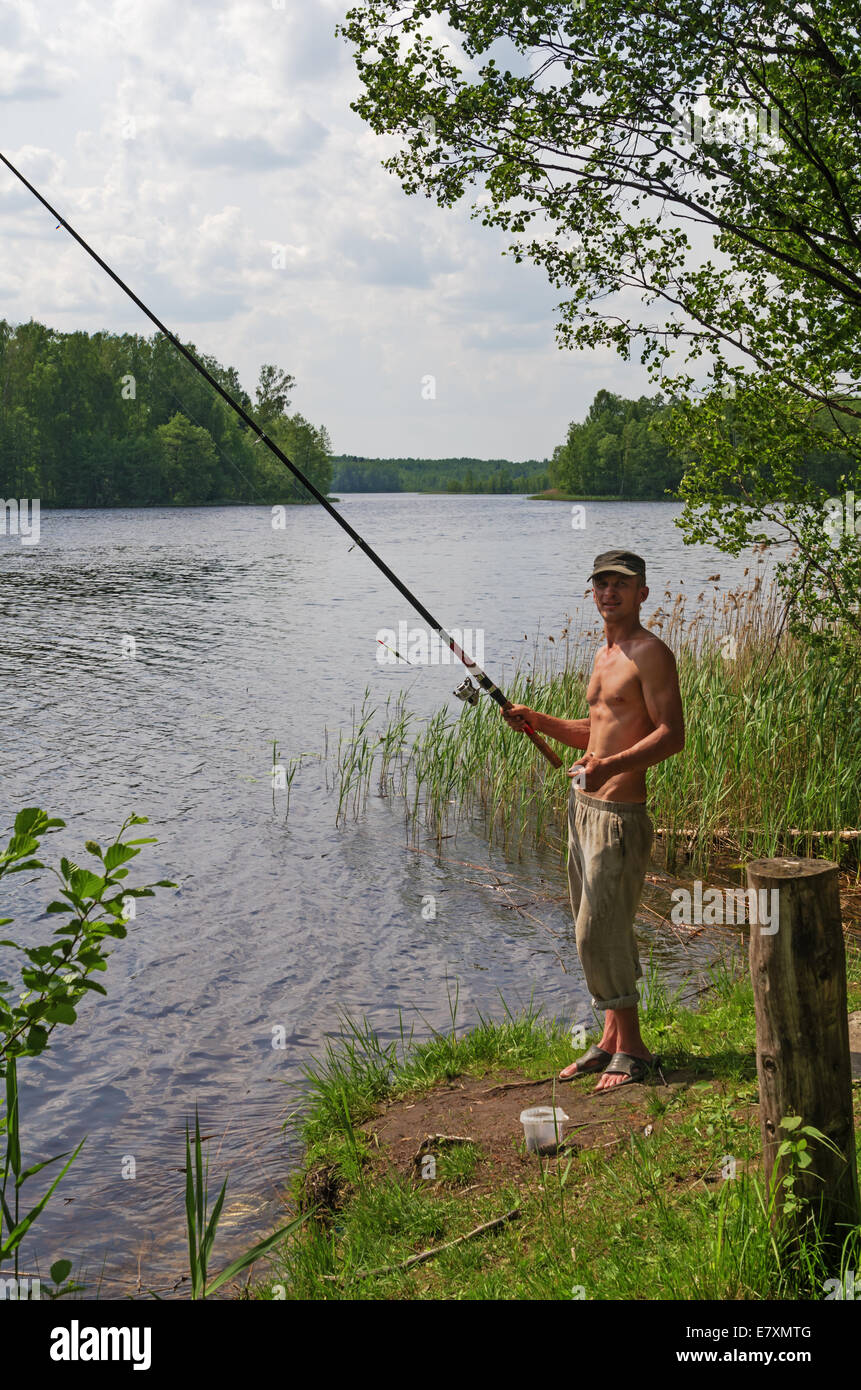 Fishing on forest lake Stock Photo - Alamy