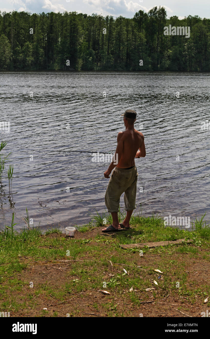 Fishing on forest lake Stock Photo - Alamy