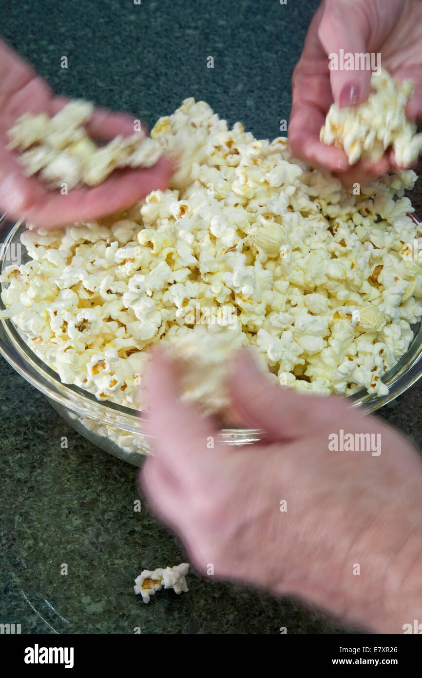People Snacking on Bowl of Popcorn Stock Photo - Alamy