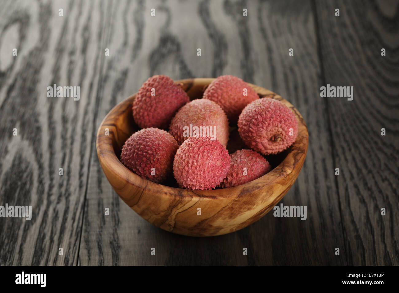 ripe lychees in wood bowl, on old oak table Stock Photo - Alamy