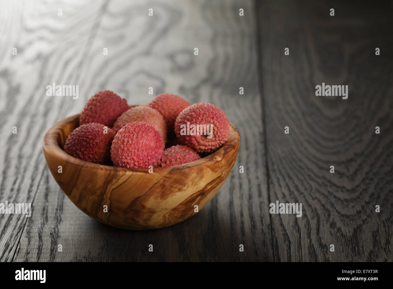 ripe lychees in wood bowl, on old oak table Stock Photo - Alamy
