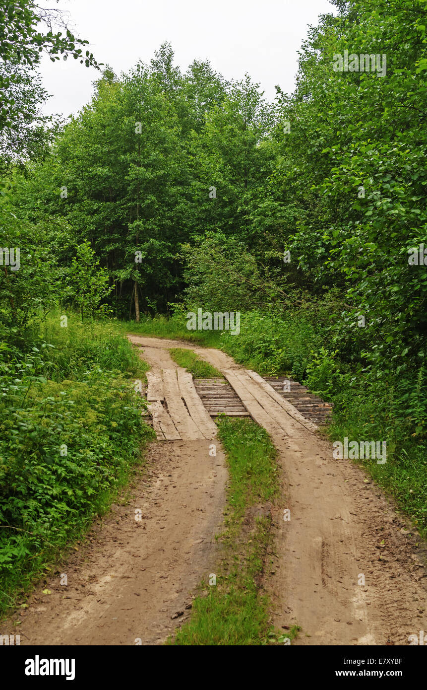 Village sand road. Bridge through small river Stock Photo - Alamy