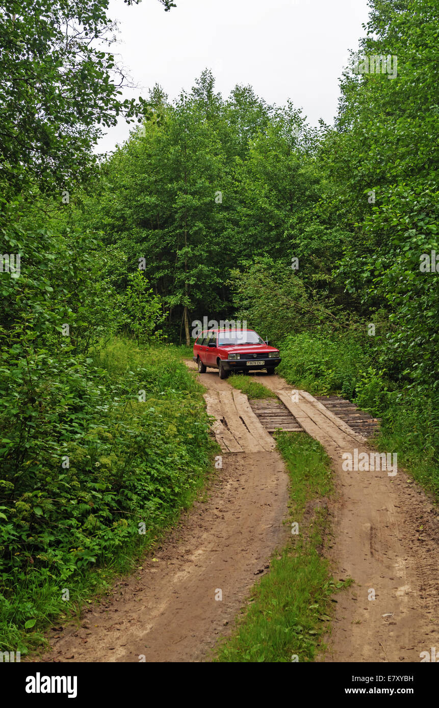 Village sand road. Bridge through small river Stock Photo - Alamy