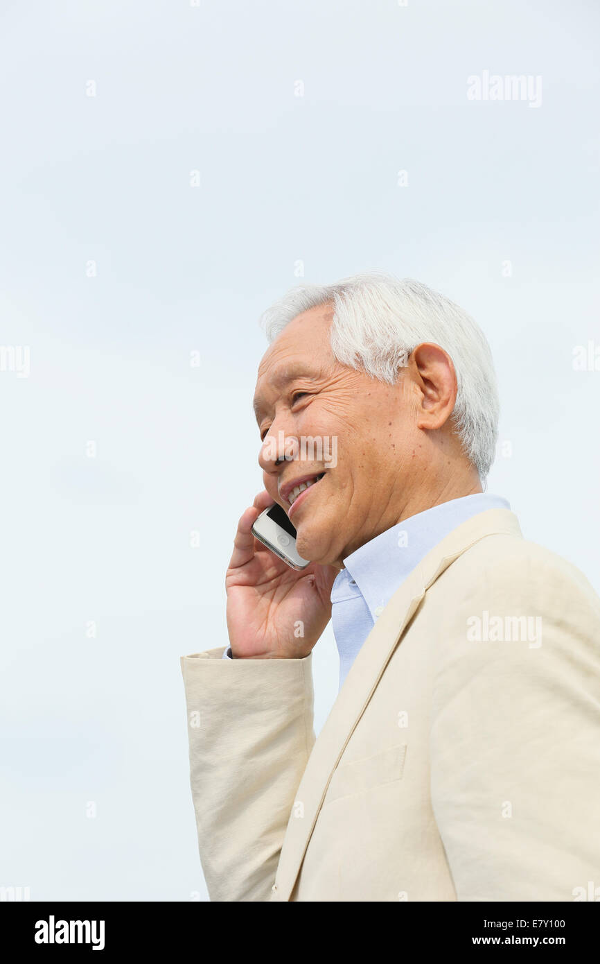 Senior adult Japanese man with smartphone in a park Stock Photo - Alamy
