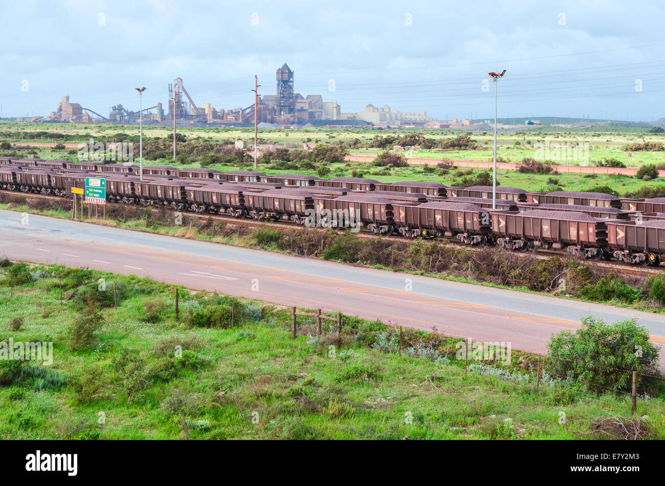 Iron ore wagons and steel works plant at the Saldanha terminal, South ...