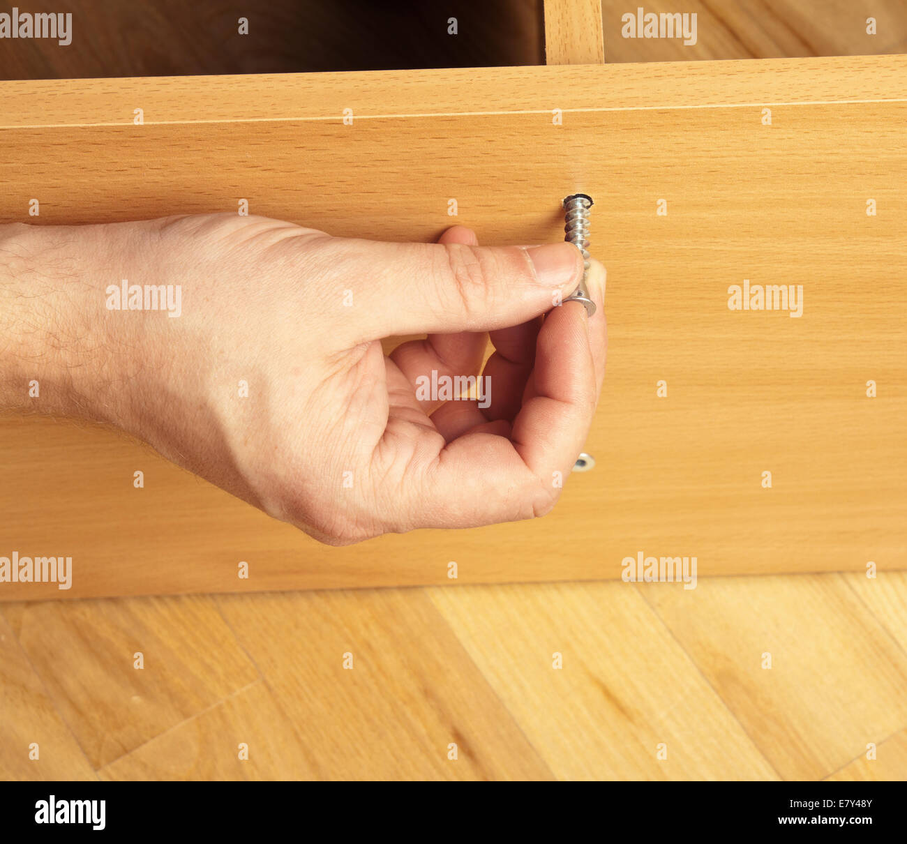 Carpenter mounting wooden furniture Stock Photo - Alamy