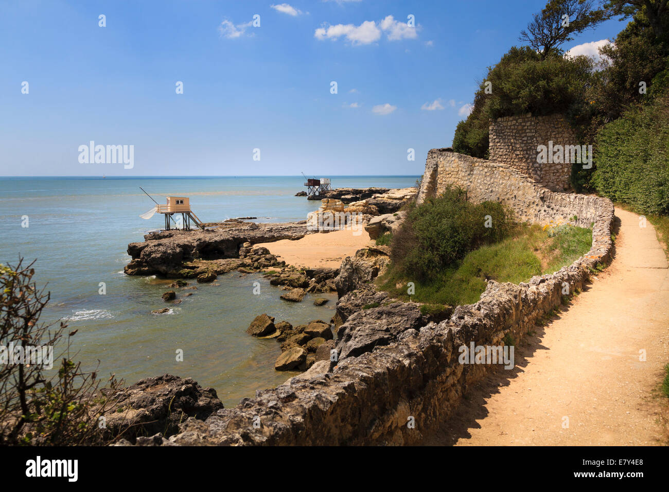 The coastal path alongside traditional fisherman huts on stilts with ...