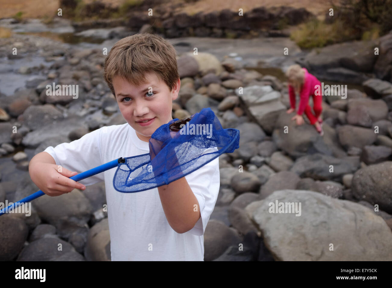 Boy catching fish fishing net hi-res stock photography and images - Alamy