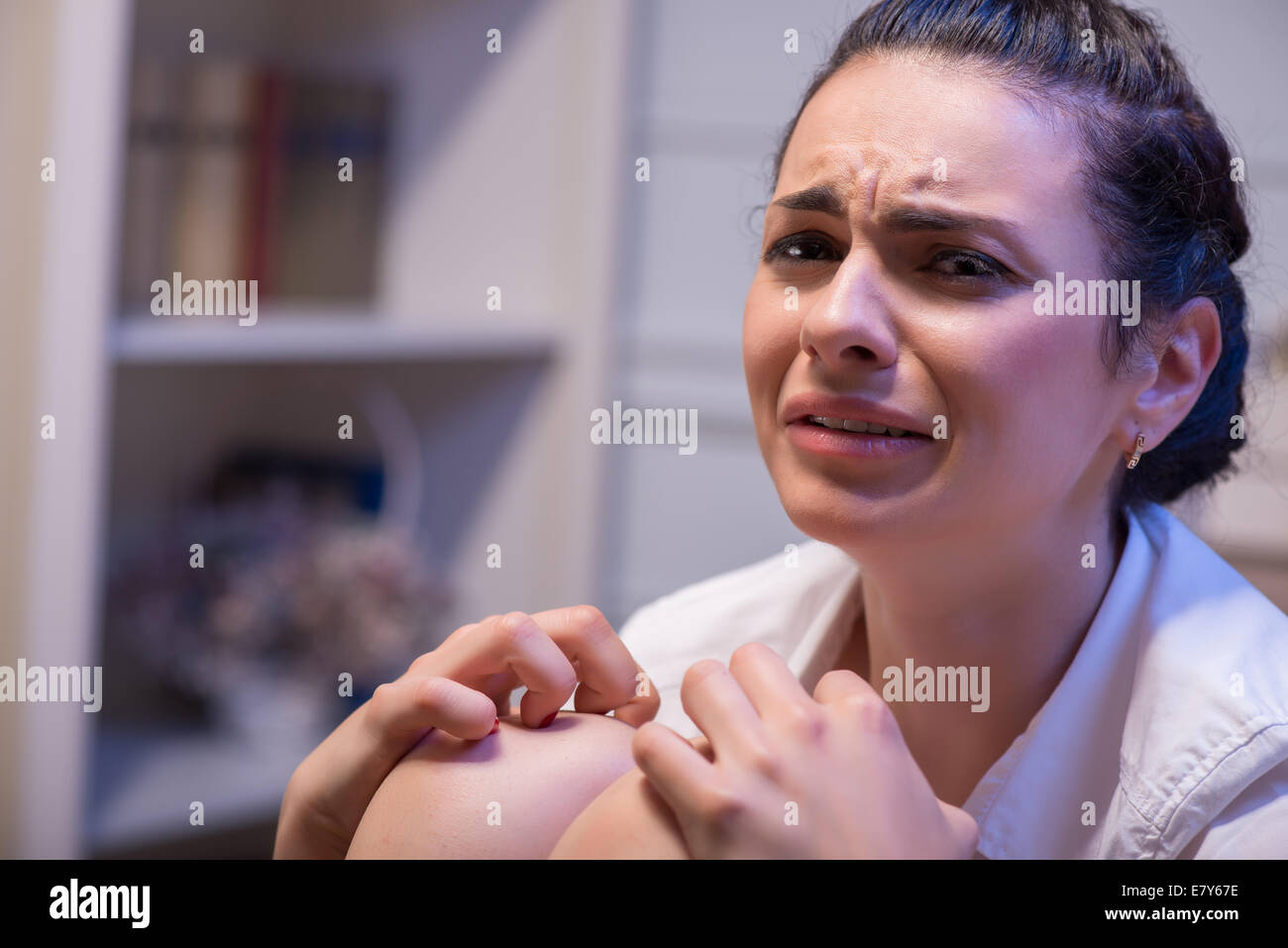 Serious woman wearing white blouse Stock Photo - Alamy