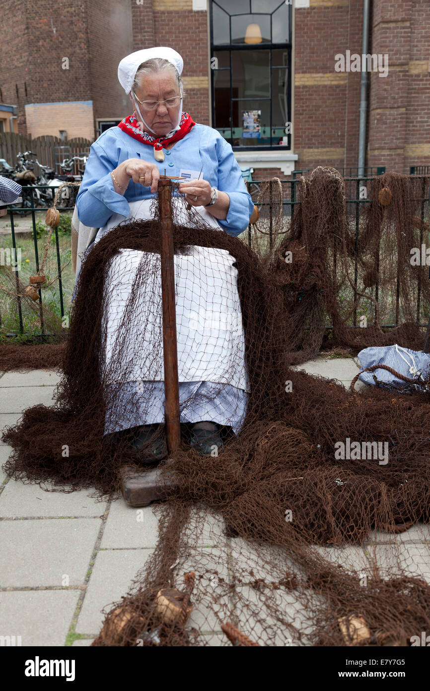 Woman repairing fishing nets hi-res stock photography and images - Alamy