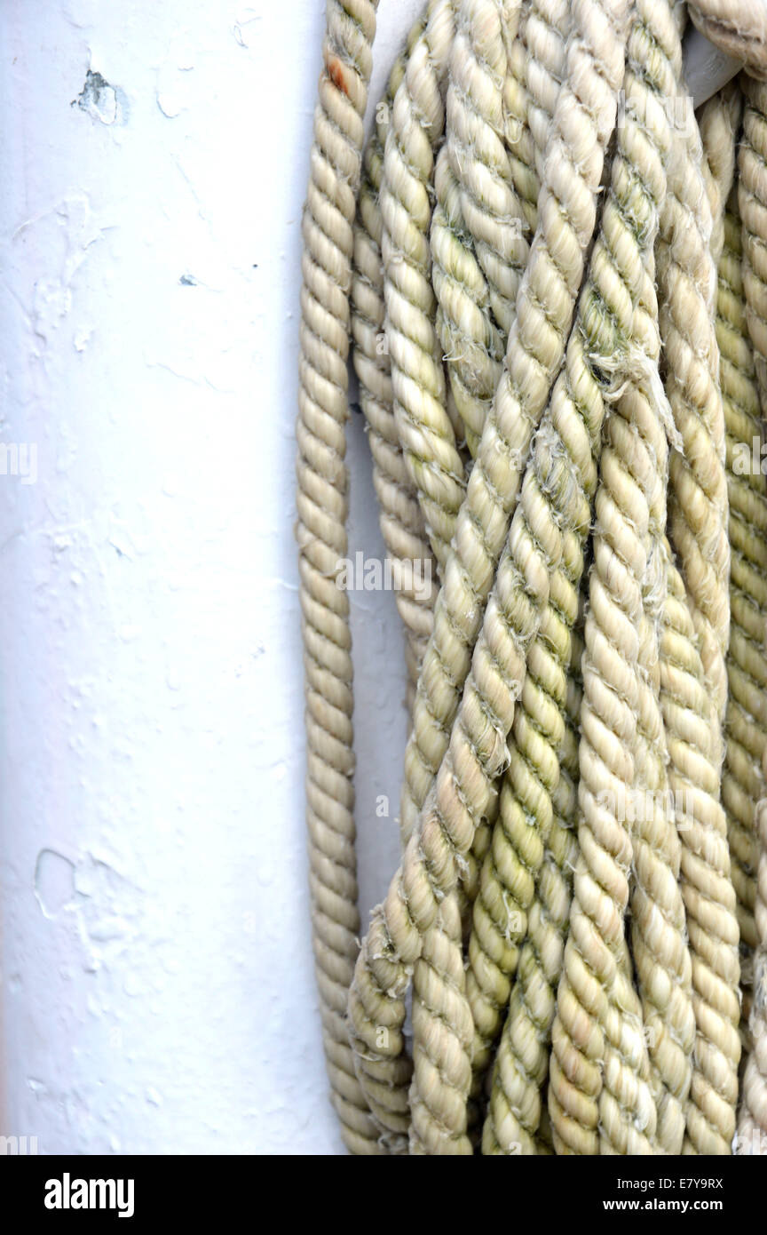 old rope on the white metal pole Stock Photo - Alamy