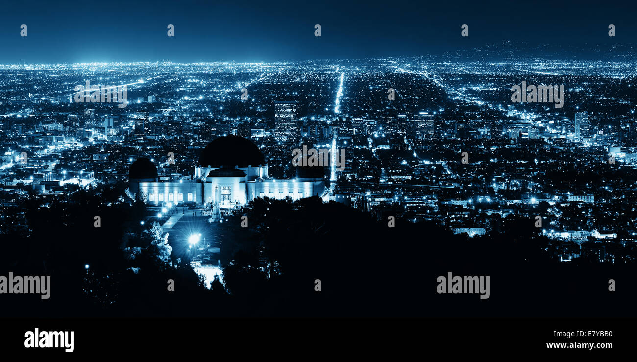 Los Angeles at night with urban buildings and Griffith Observatory ...