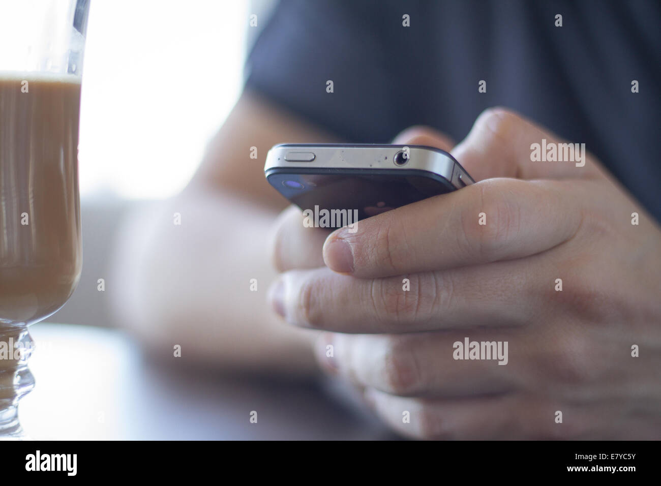 Man holding an iphone in hands Stock Photo - Alamy