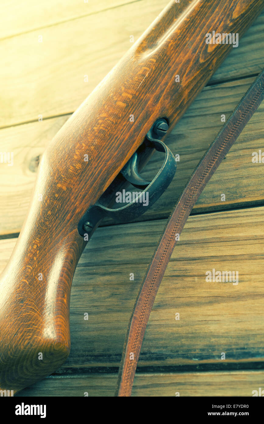 rifle on a wooden background. Vintage Stock Photo - Alamy