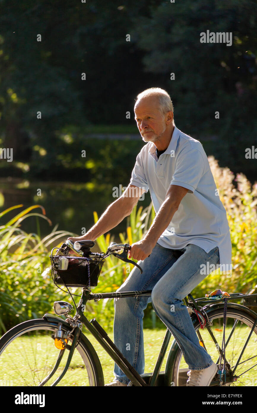 Senior Man Riding Bicycle Stock Photo - Alamy