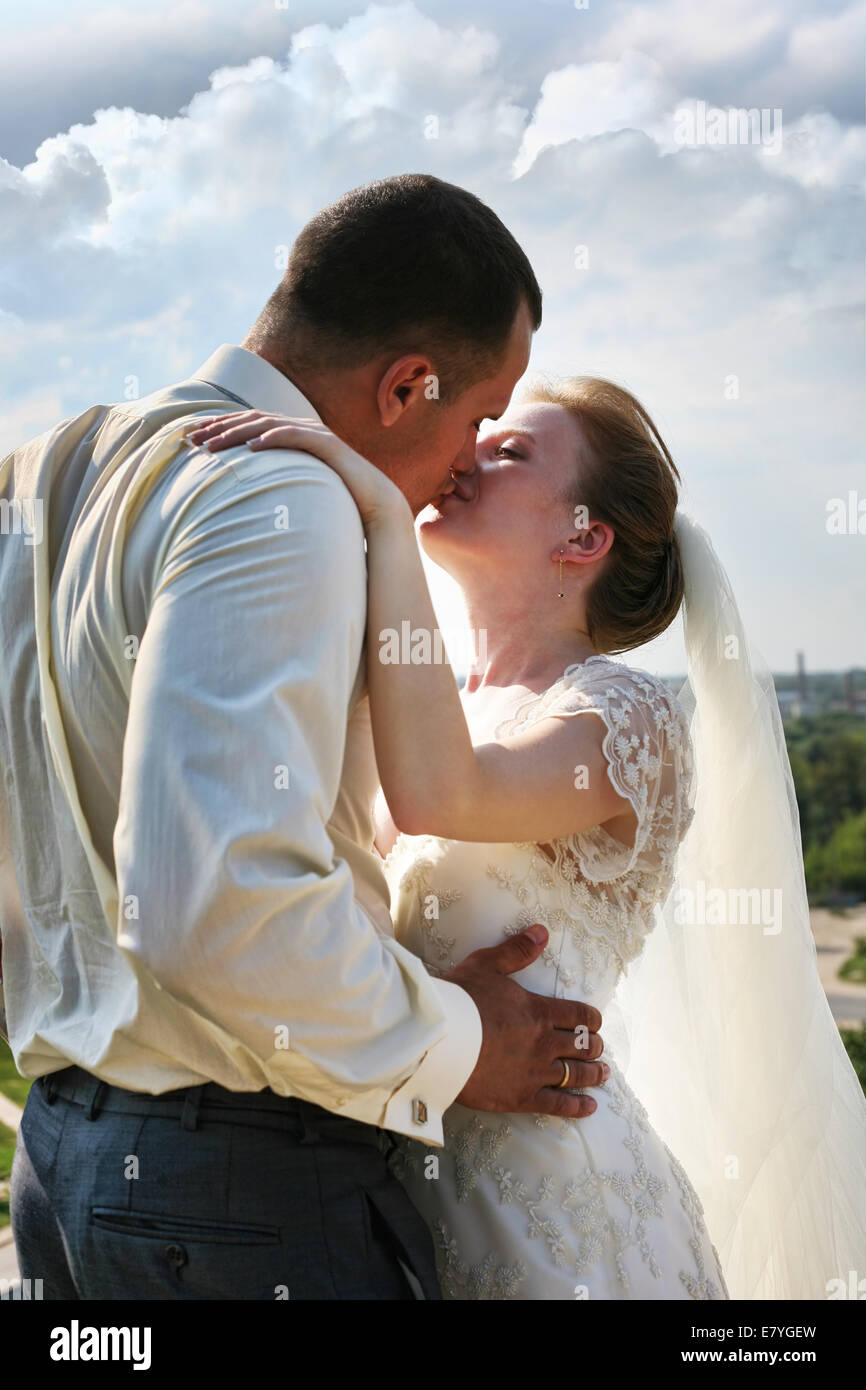 Beautiful the bride and the groom kiss Stock Photo - Alamy
