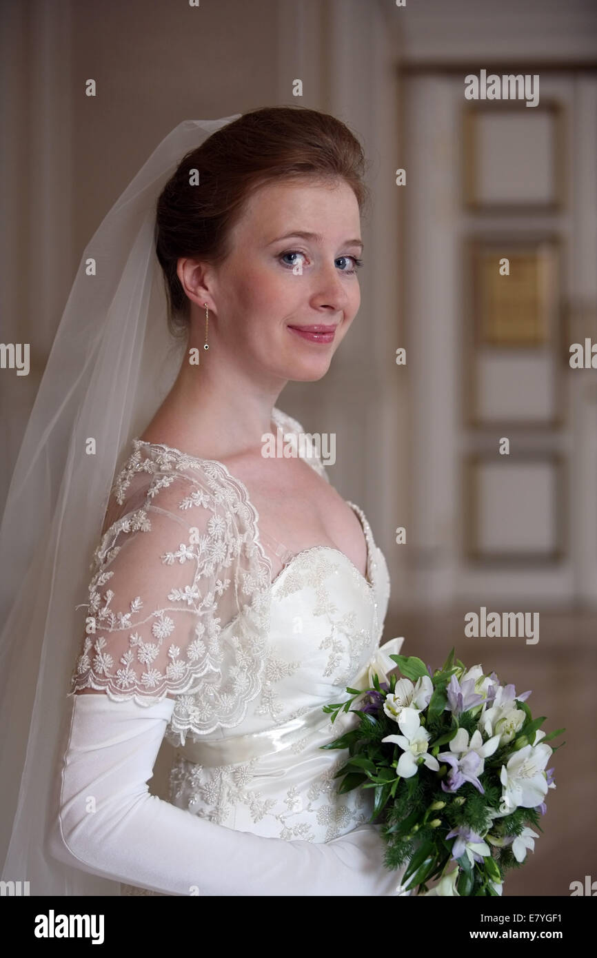The beautiful bride with a bouquet in an interior Stock Photo - Alamy