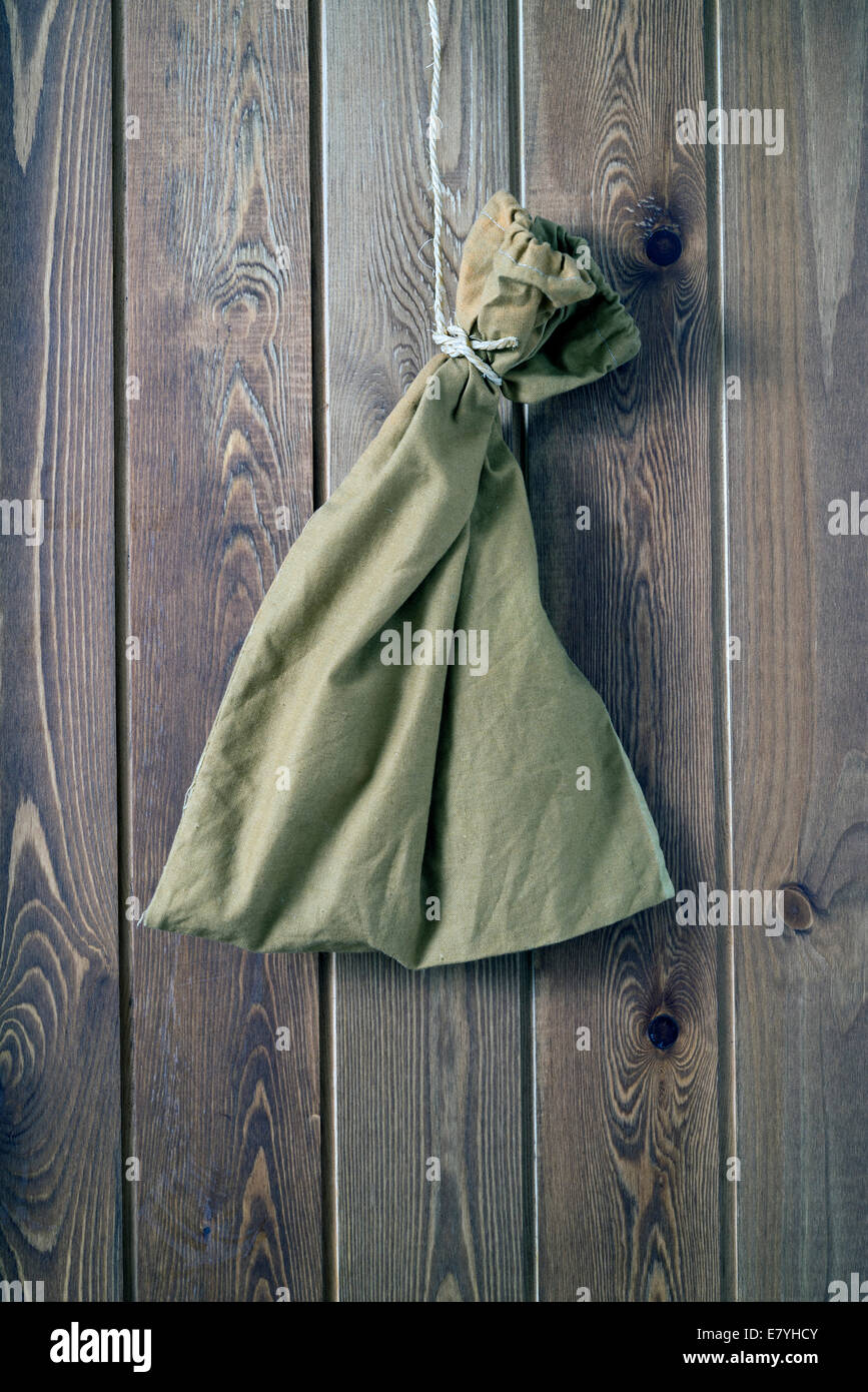 Sack hanging from a string. Wood backgroun Stock Photo - Alamy
