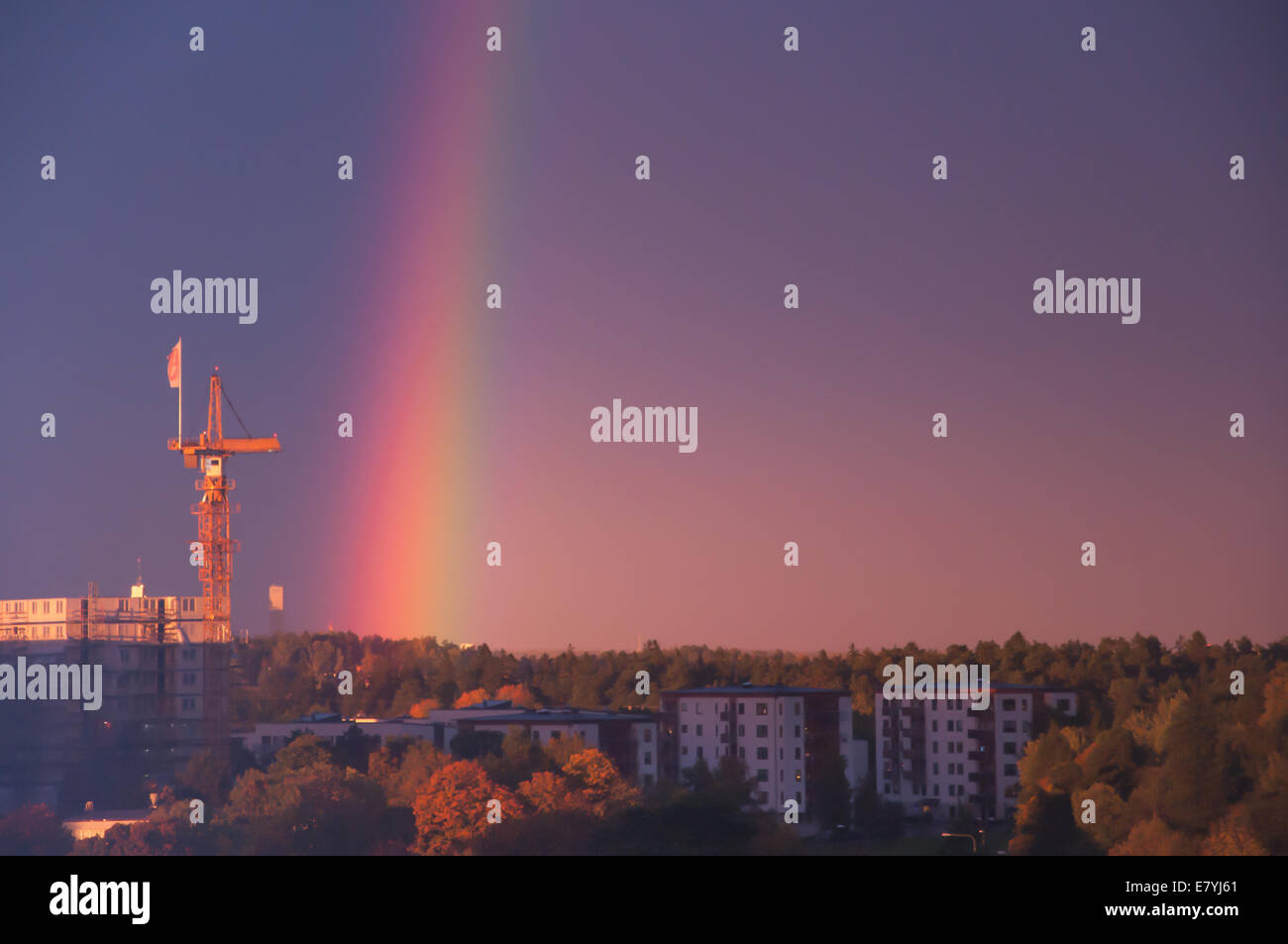 Building crane and rainbow. New Vallingby Park City being constructed ...