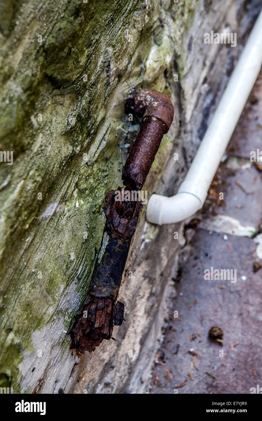 Old rusted pipe and new pipe installed on an old murret stones Stock ...
