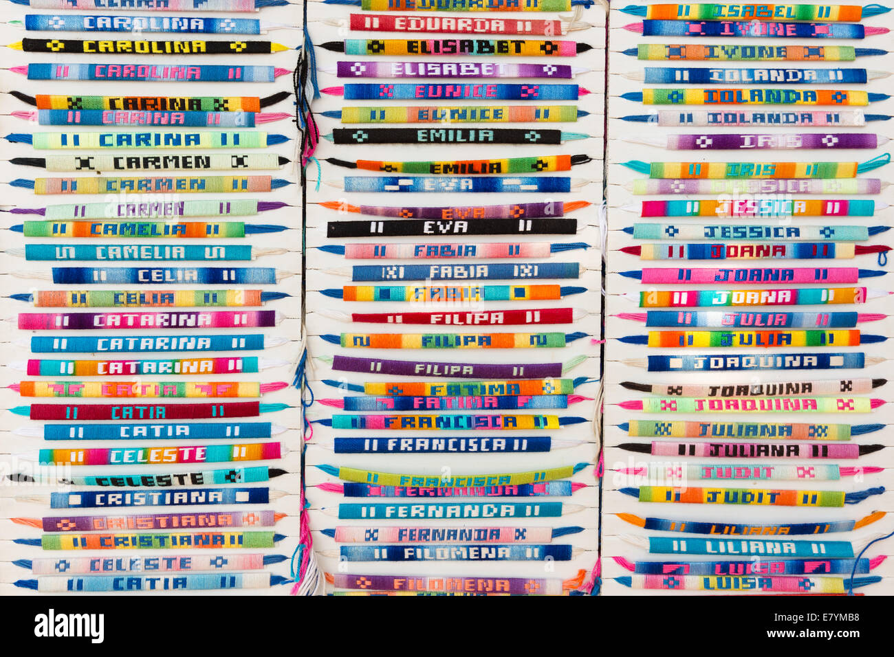 Colorful arm bracelets with several embroidered names Stock Photo - Alamy