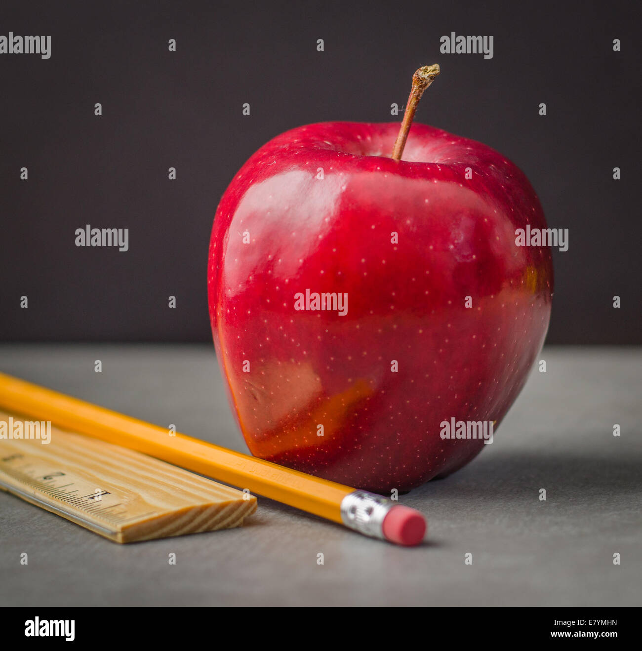 Red apple with yellow pencil and ruler Stock Photo - Alamy