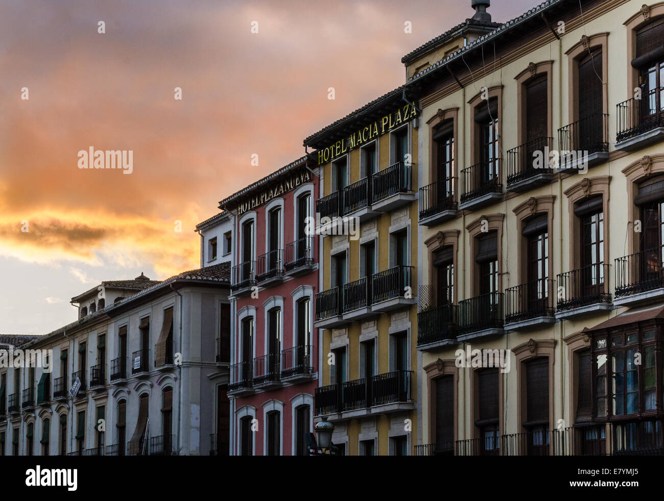 Row of historic colorful building facades in Granada, Spain with a ...