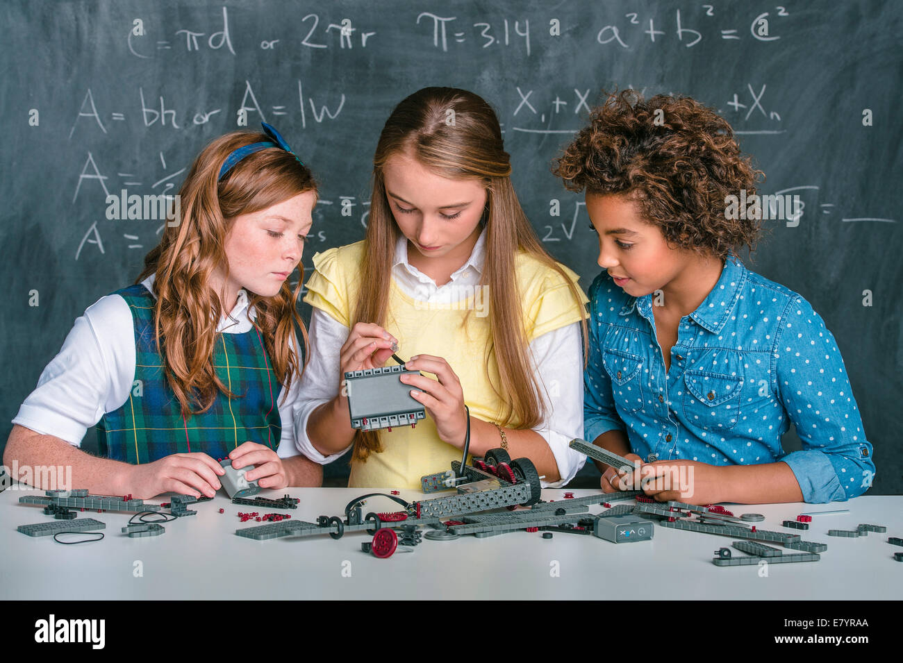Three girls in classroom Stock Photo - Alamy