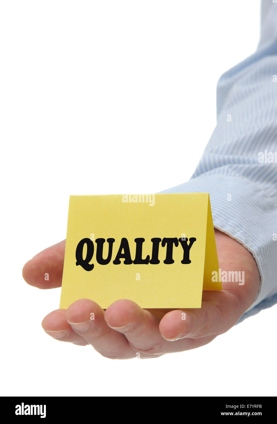 Business man holding yellow quality sign on hand Stock Photo - Alamy