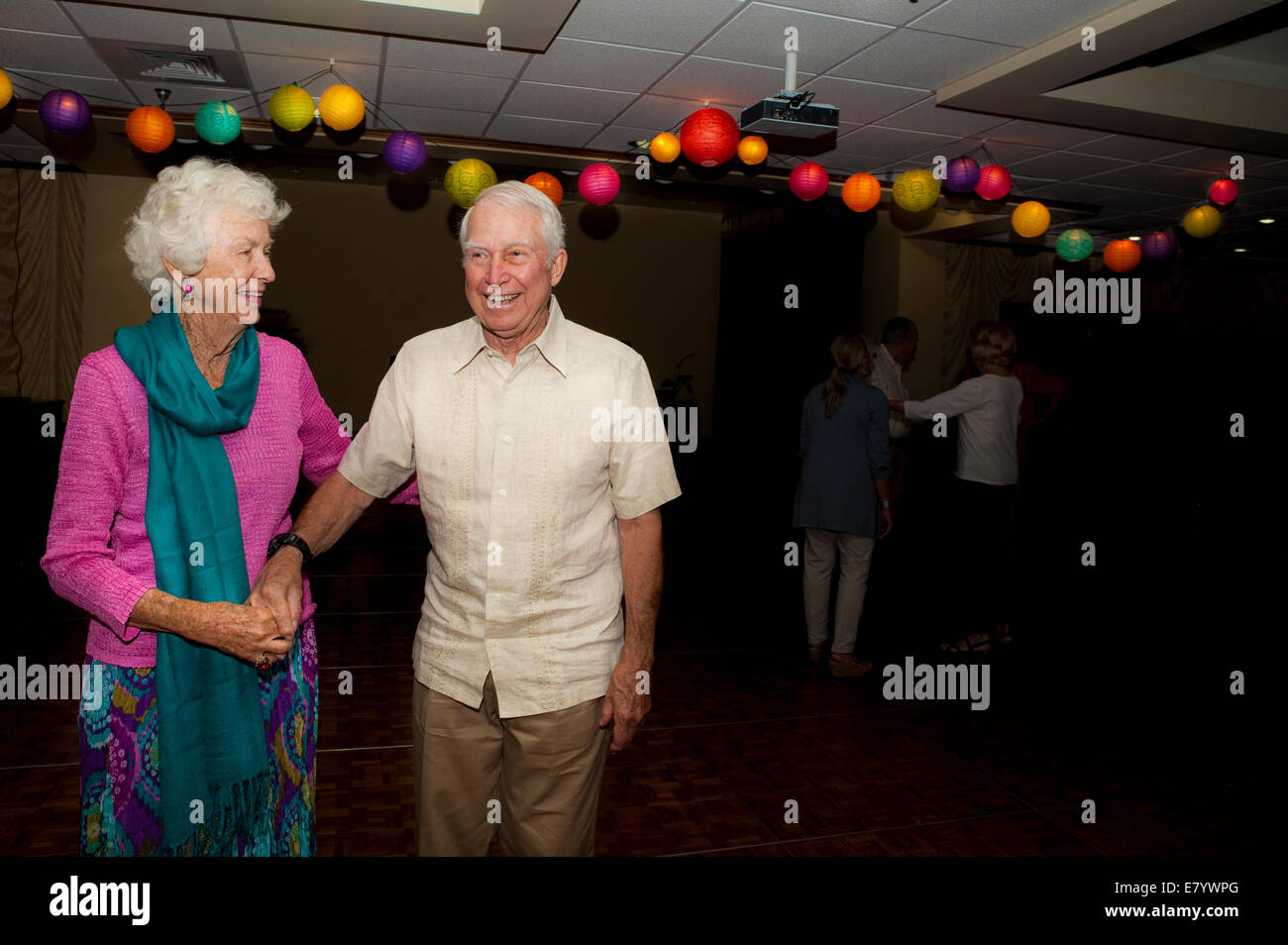 Two elderly people holding hands Stock Photo - Alamy