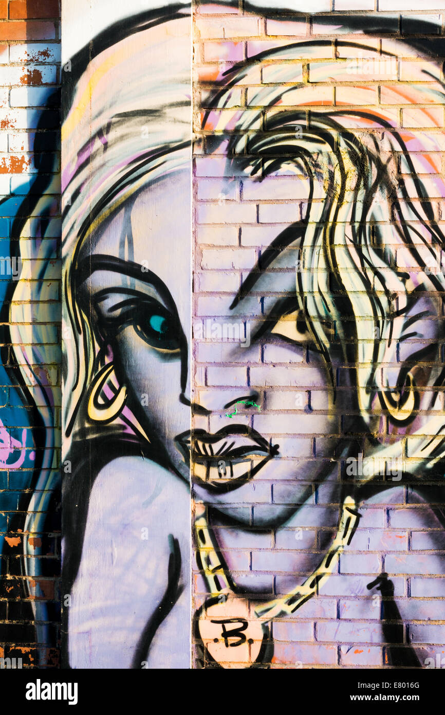 long blond hair hip hop girl with necklace graffiti on a brick wall ...