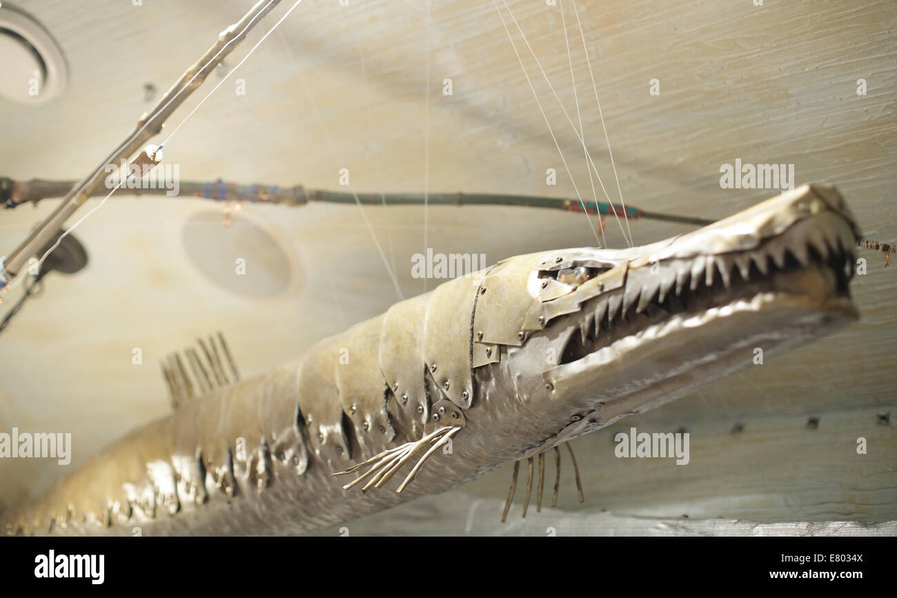 modern handmade iron fish decoration in wooden interior Stock Photo - Alamy