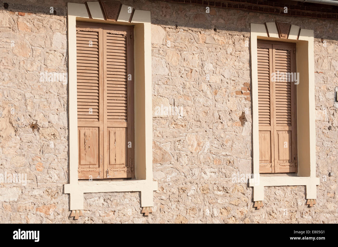 Two closed wooden windows on stone house wall Stock Photo - Alamy