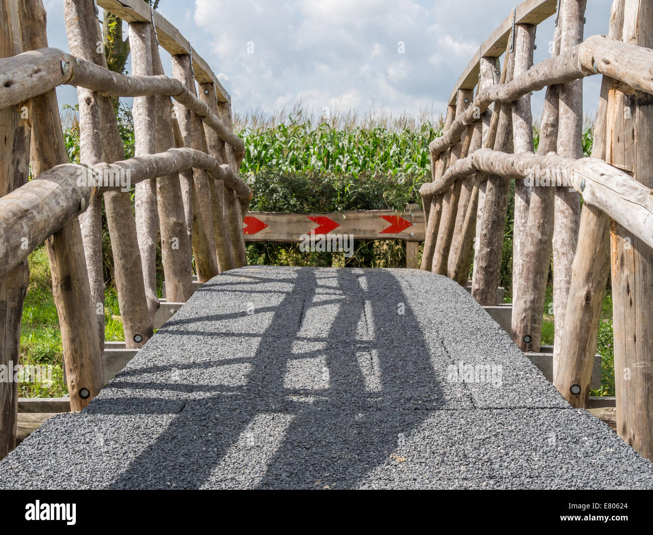 Closeup horizontal of wooden bridge with arrows Stock Photo - Alamy